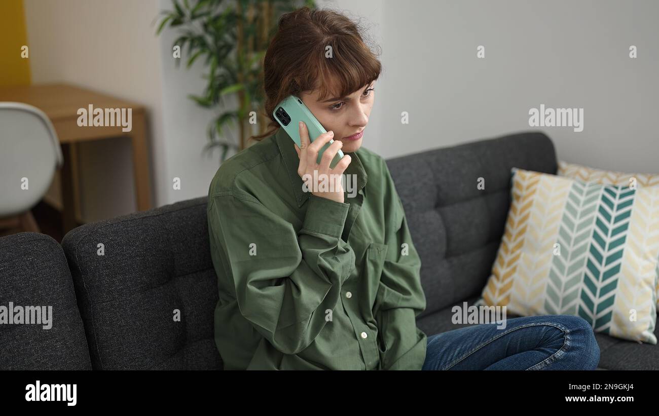 Young caucasian woman talking on the phone with disgust at home Stock ...