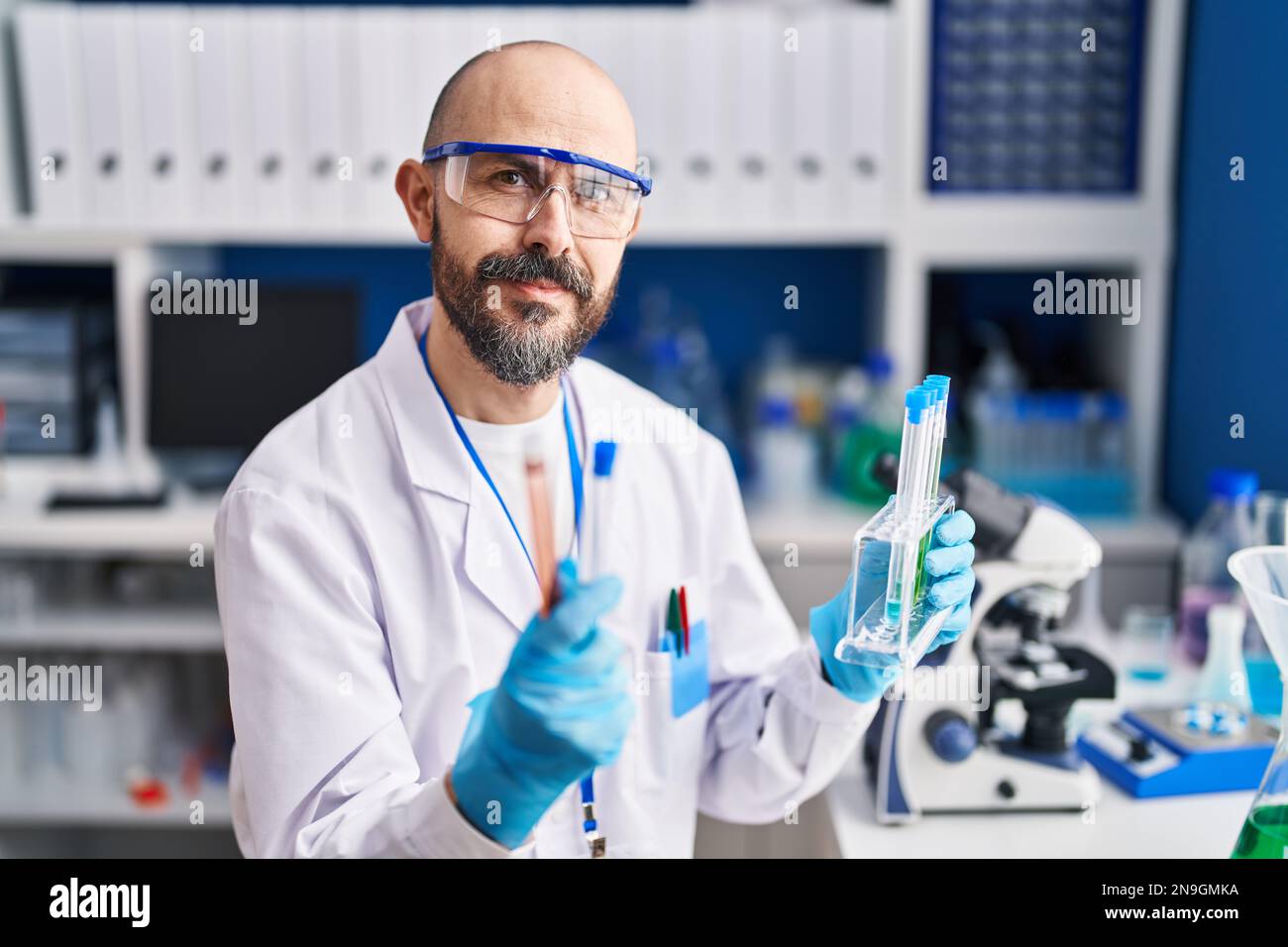 Young bald man scientist holding test tubes at laboratory Stock Photo ...