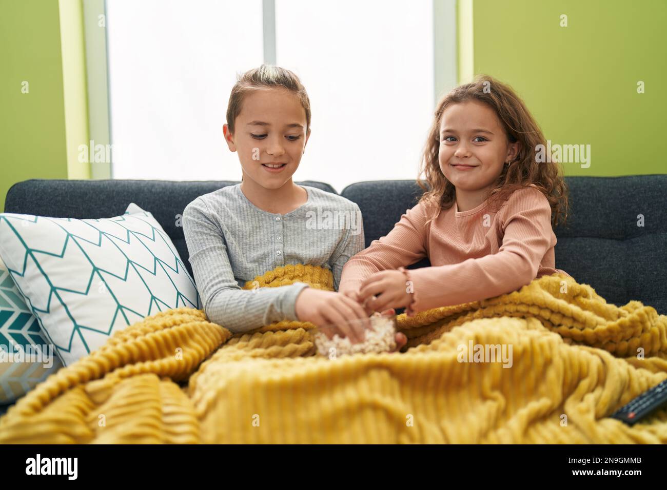 Two kids eating popcorn hi-res stock photography and images - Alamy