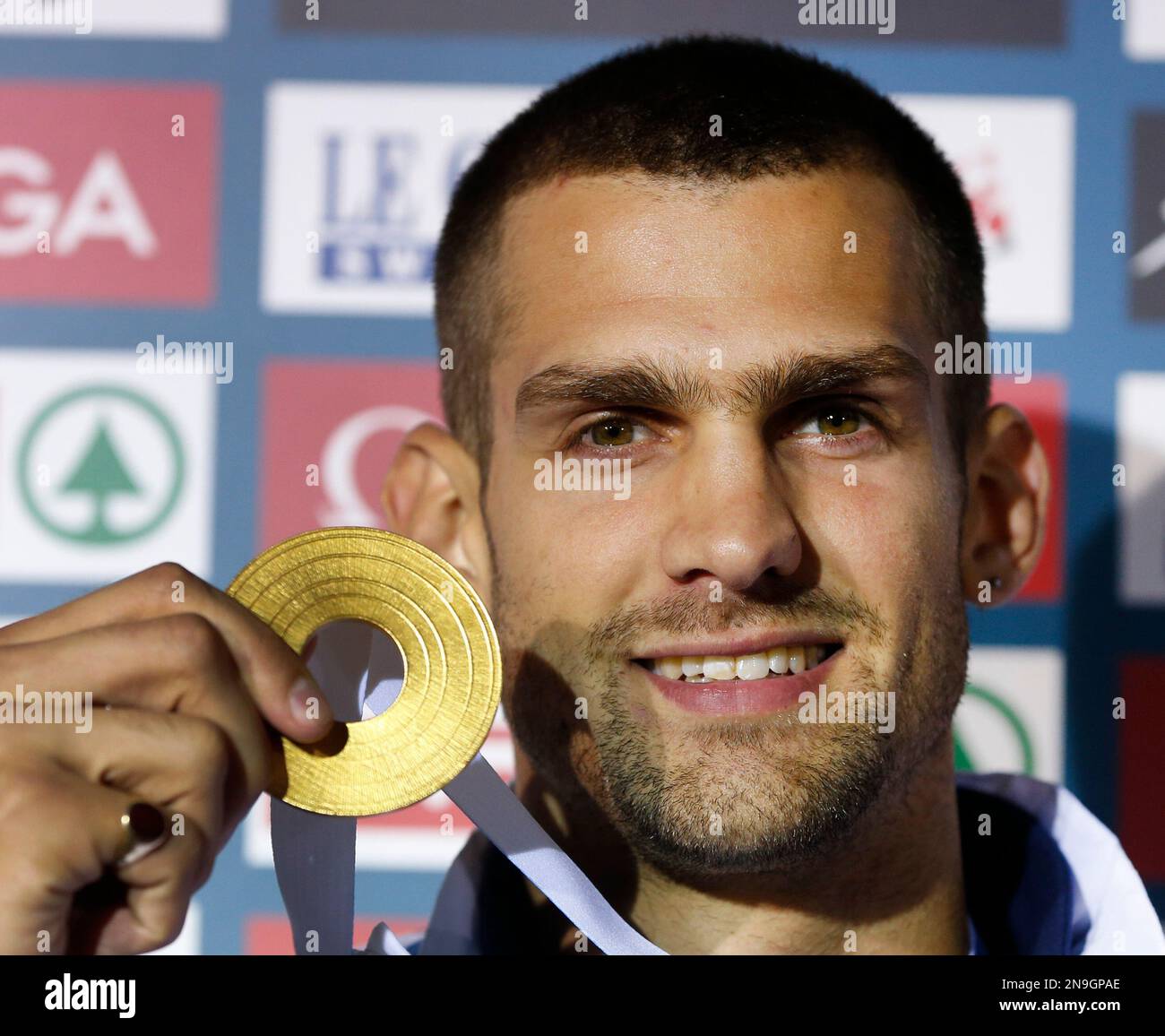 Britain's Robbie Grabarz displays the gold medal he won in the Men's ...