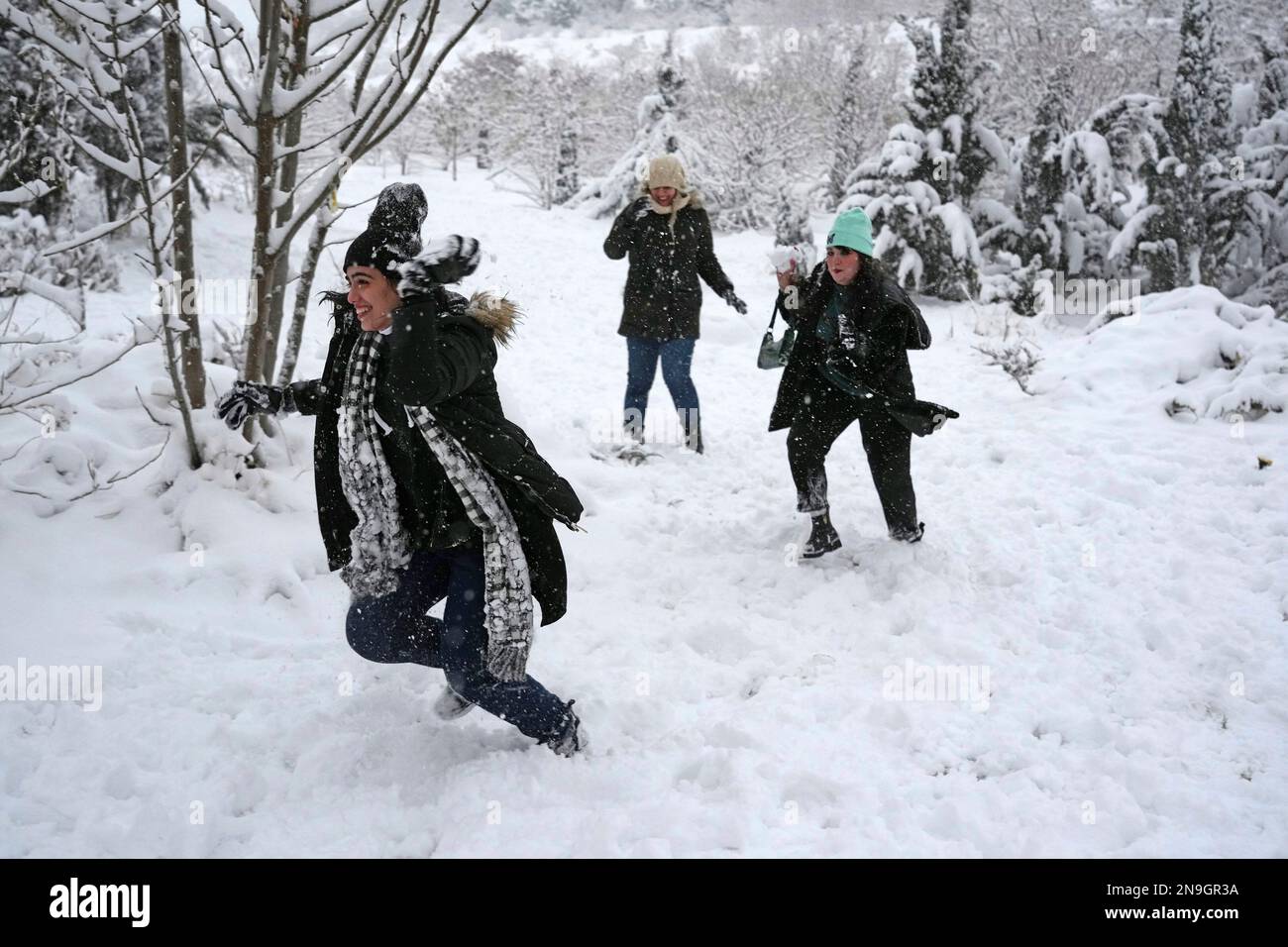 Young women play in the snow at Pardisan Park in Tehran, Iran, Sunday ...