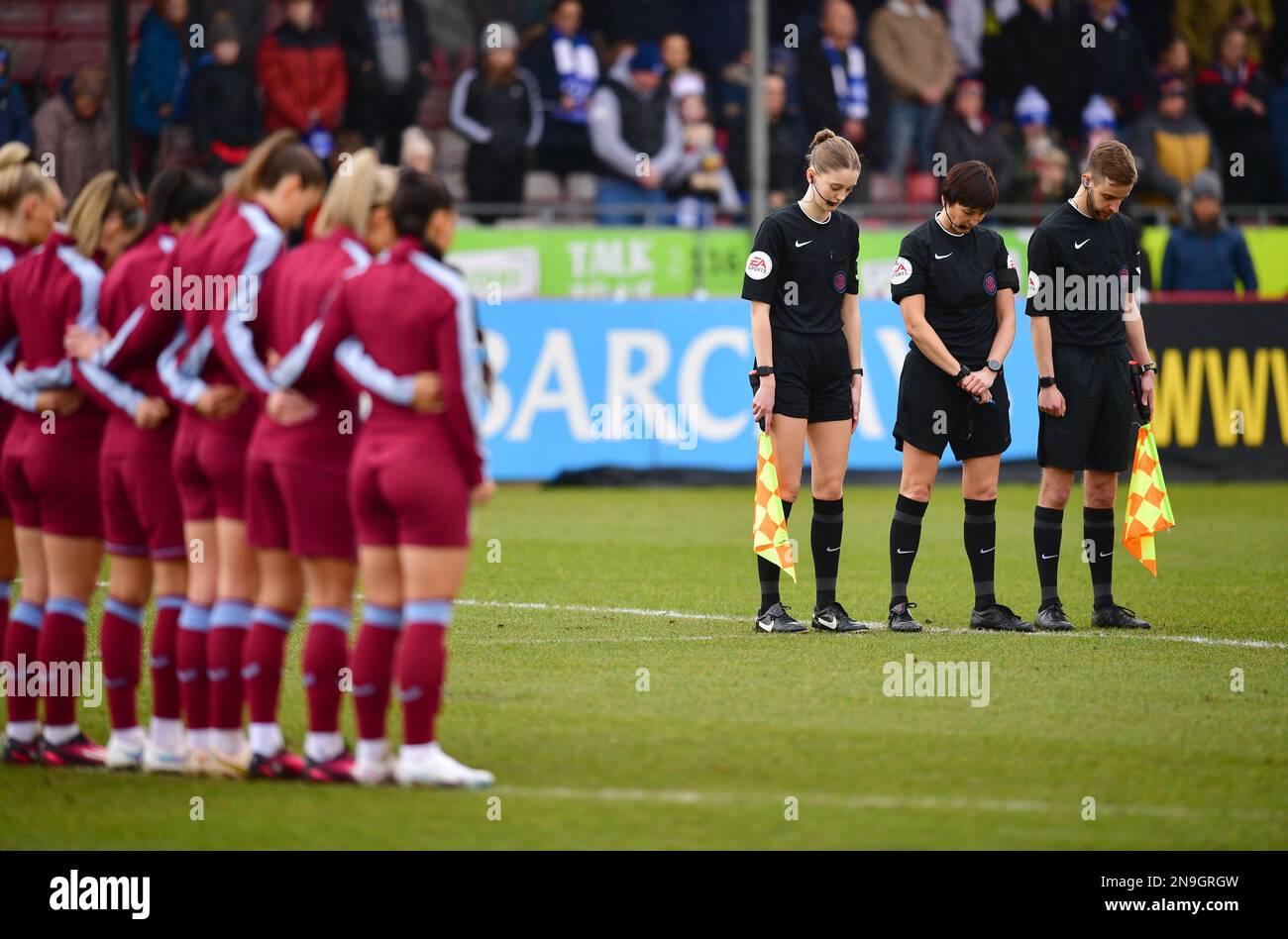 Crawley, UK. 12th Feb, 2023. Players and officials respect a minutes ...