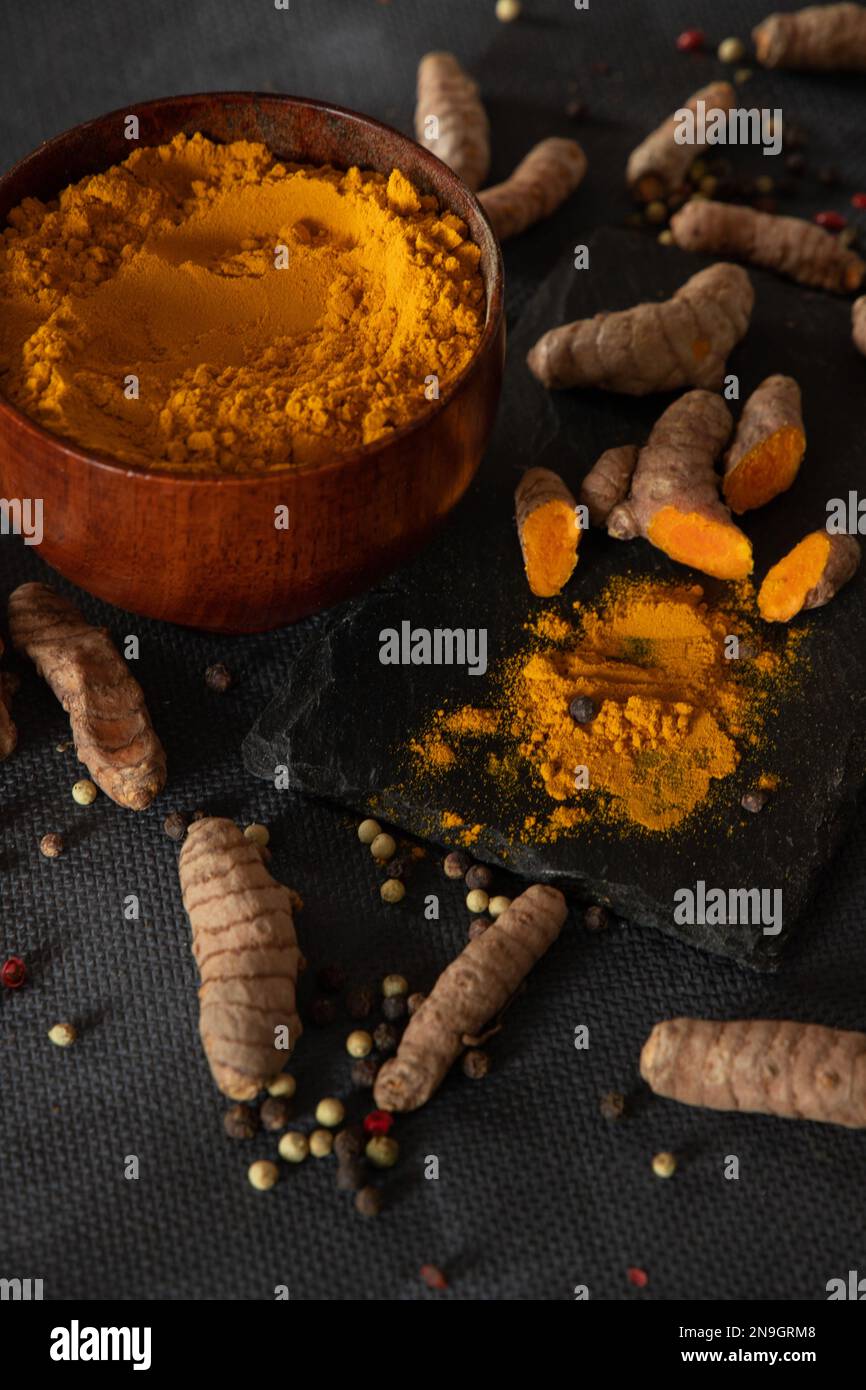 turmeric roots and powder with peppercorns. healthy spice concept Stock ...