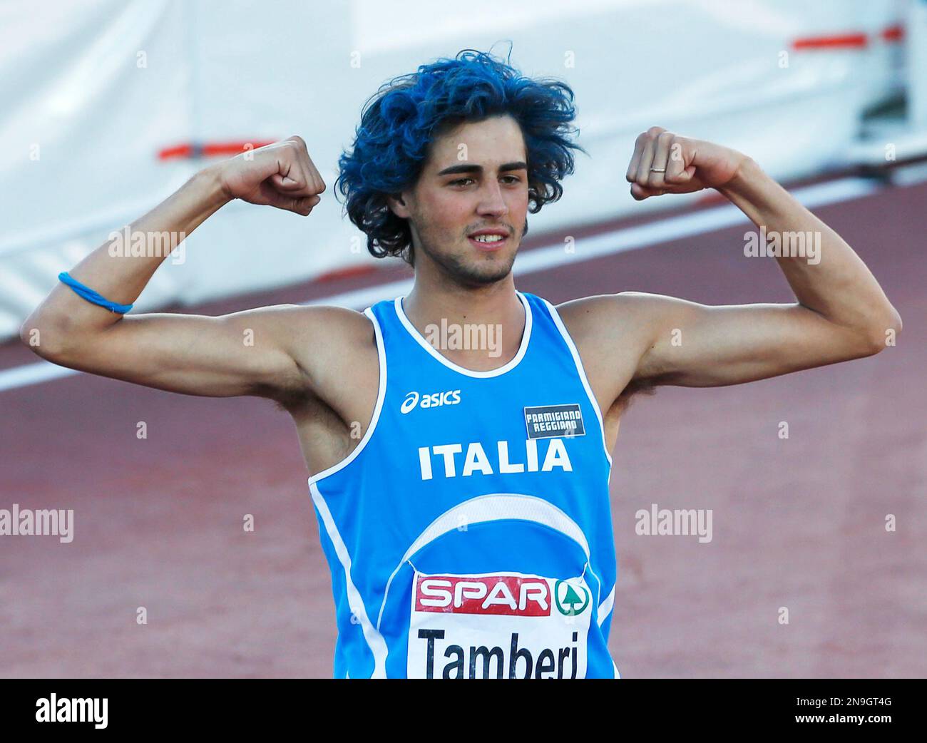 Italy's Gianmarco Tamberi has his hair colored blue as he competes in ...