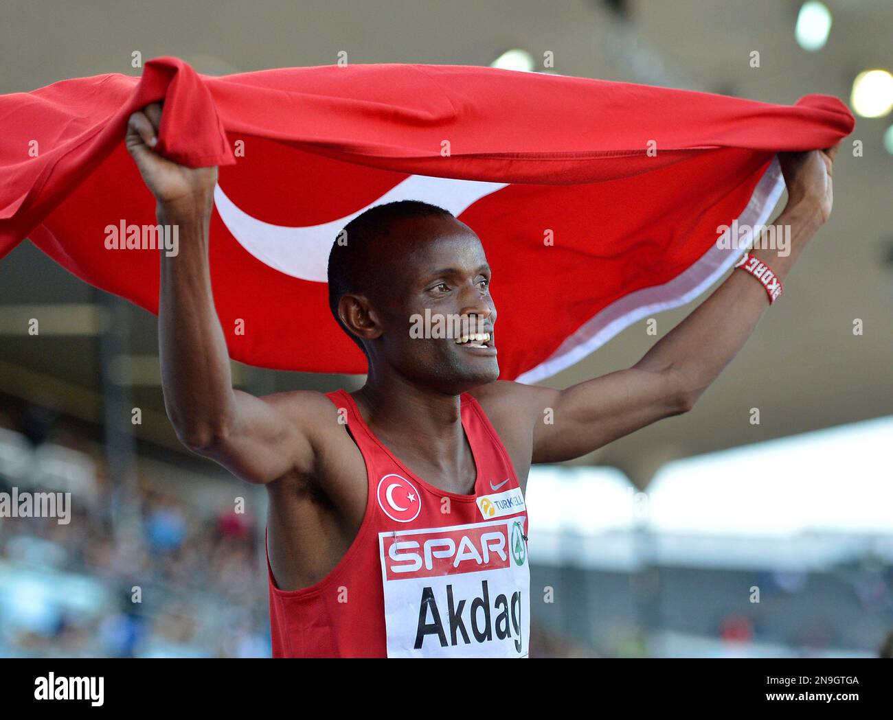 Turkey's Tarik Langat Akdag carries a national flag after winning ...