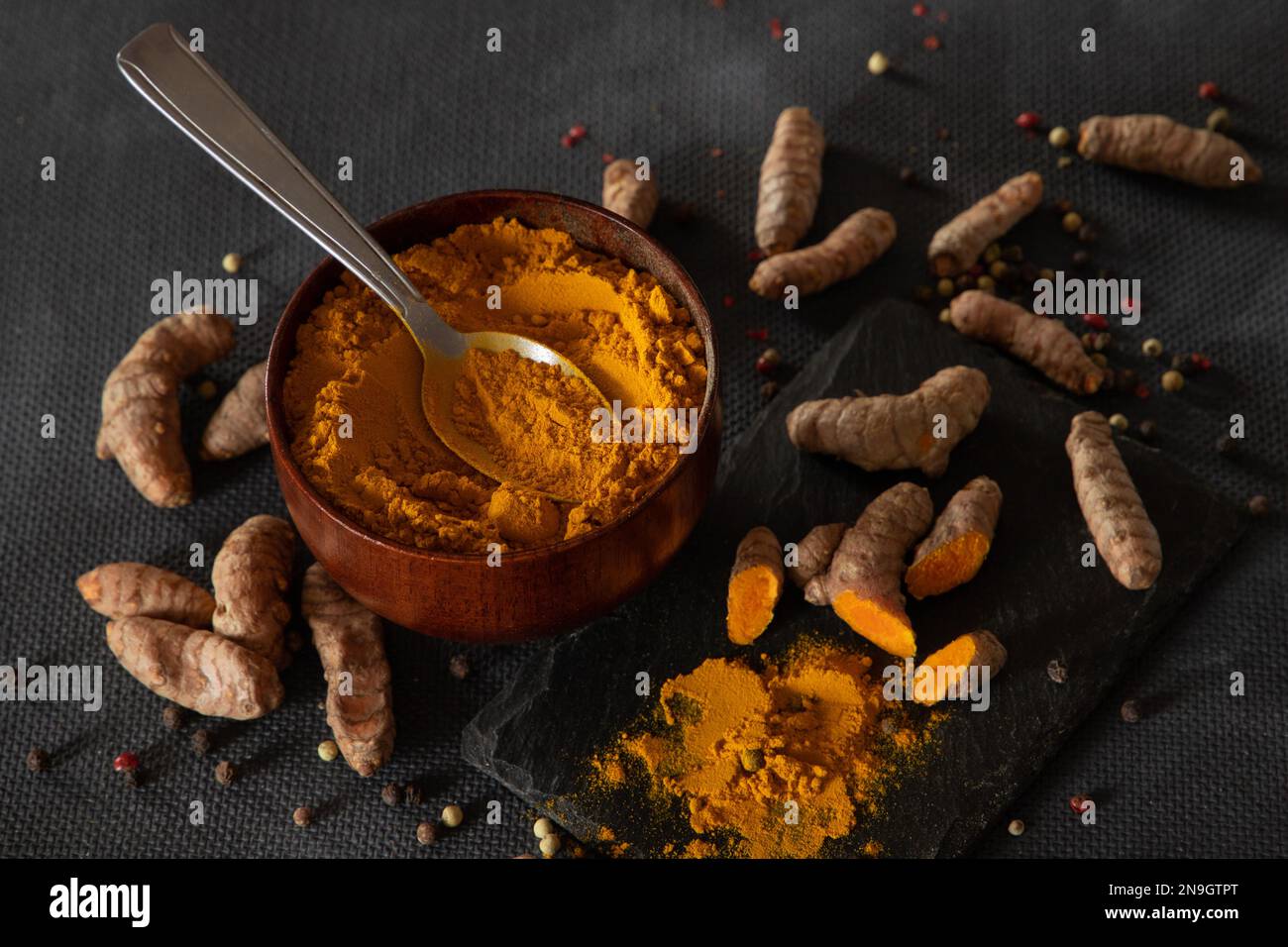 turmeric roots and powder with peppercorns. healthy spice concept Stock ...