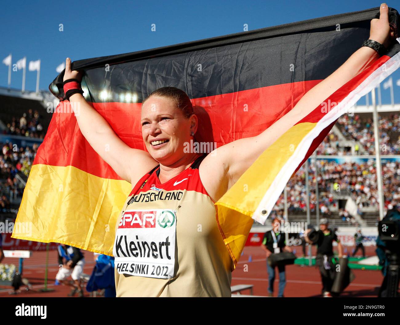 Germany's Nadine Kleinert poses with the national flag after winning ...
