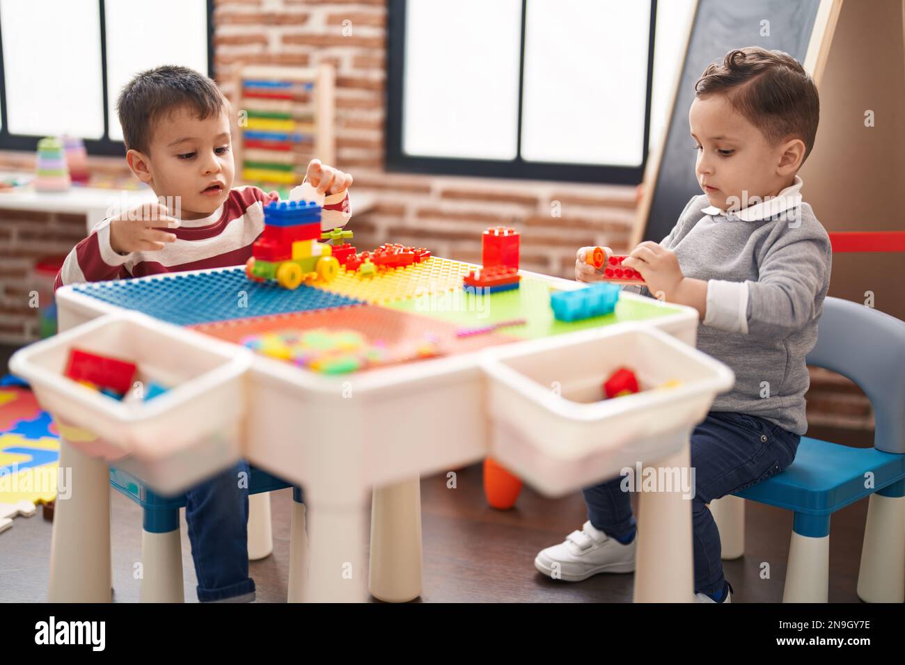 Hispanic kids playing with blocks hi-res stock photography and images ...