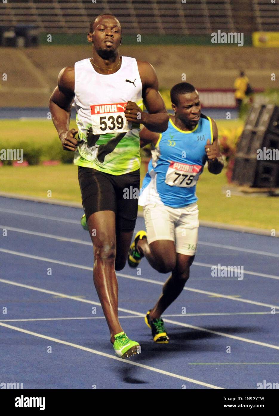 World record holder Usain Bolt, left, runs ahead of countryman Kimmari ...