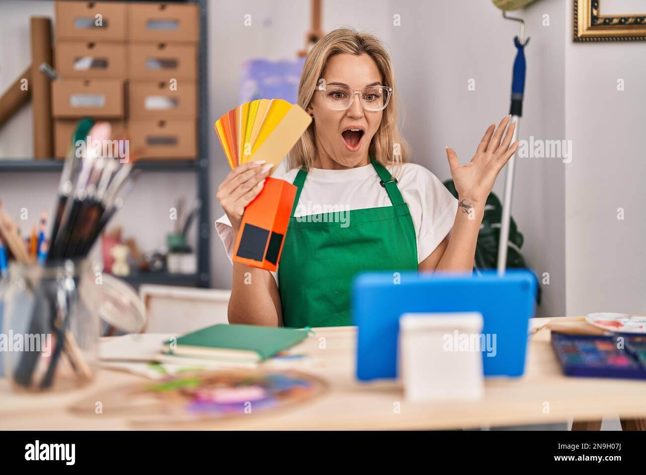 Young caucasian woman doing video call showing color palette ...
