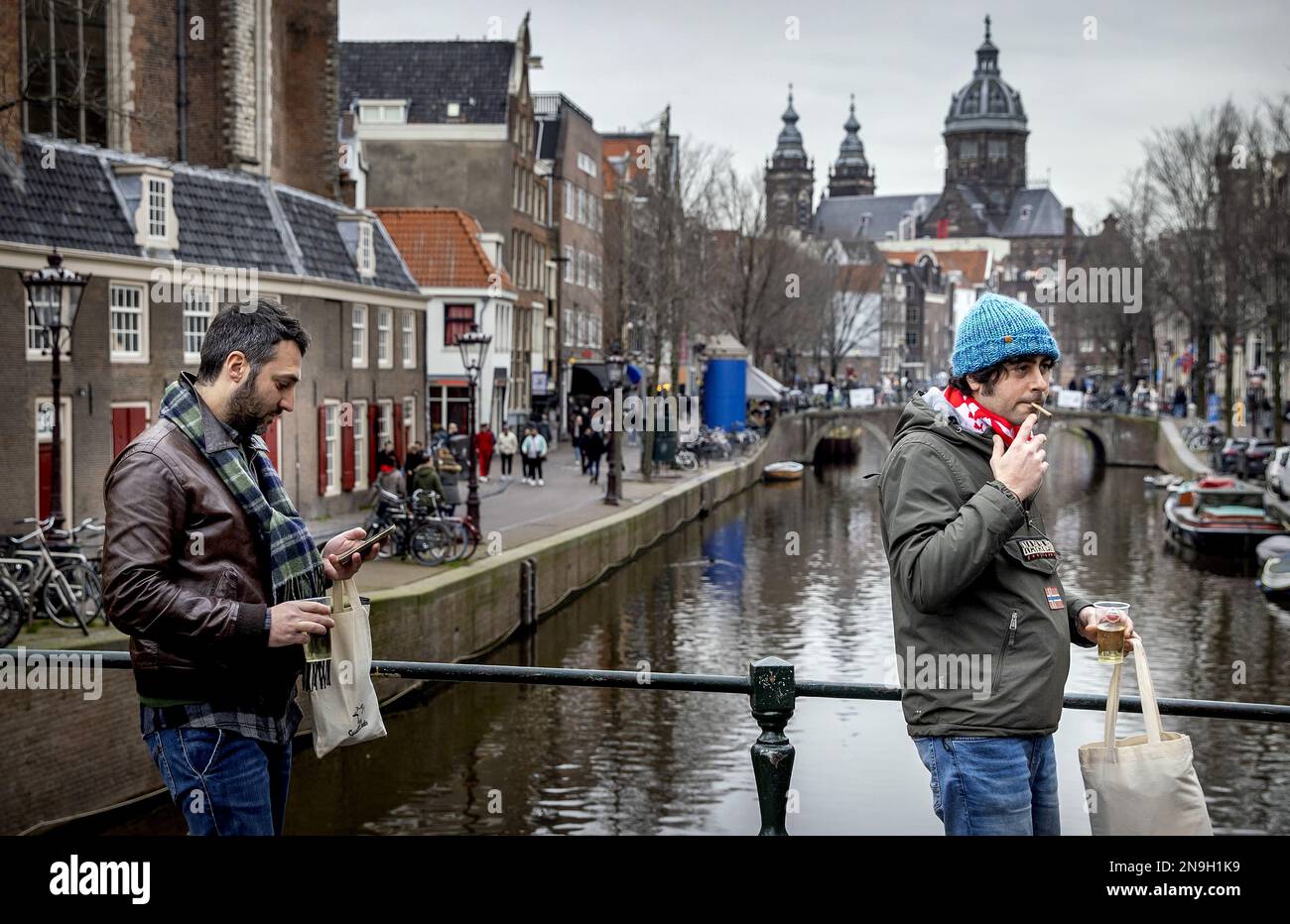 AMSTERDAM - A tourist with a joint in the Red Light District. In the ...