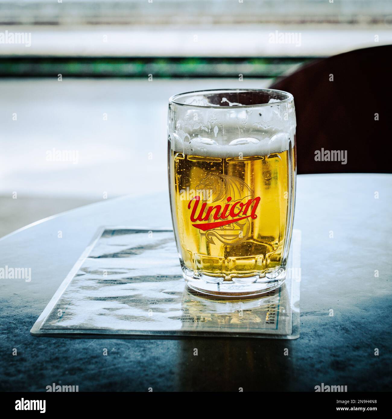 A mug full of beer stands at the menu at the table at the platform of ...