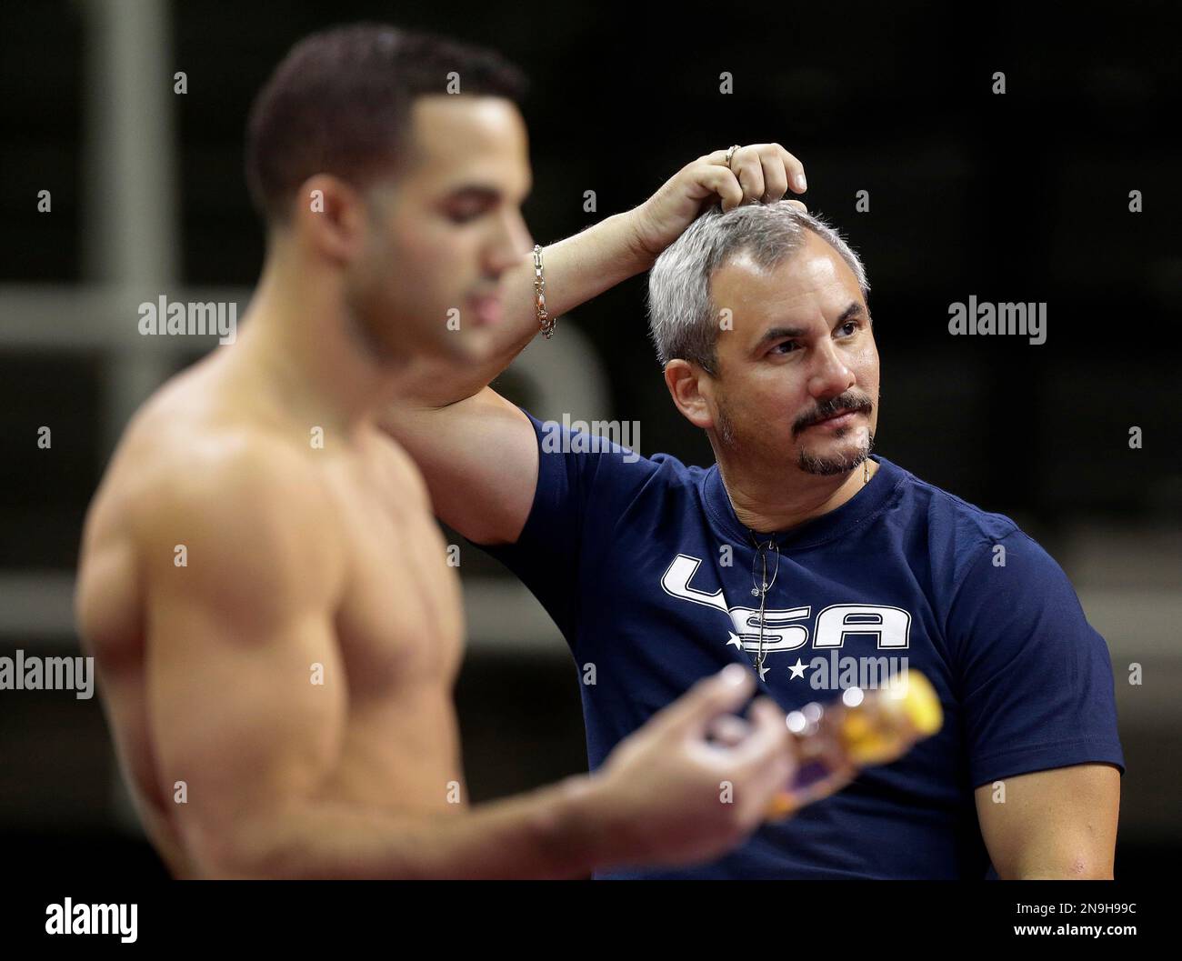 Coach Yin Alvarez, right, watches as his stepson, Danell Leyva, and ...