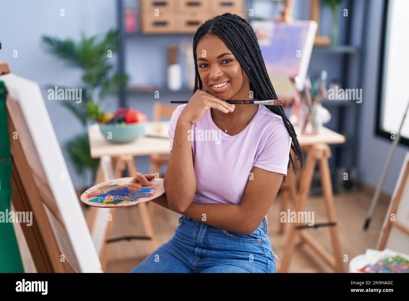 African american woman artist smiling confident drawing at art studio Stock Photo - Alamy