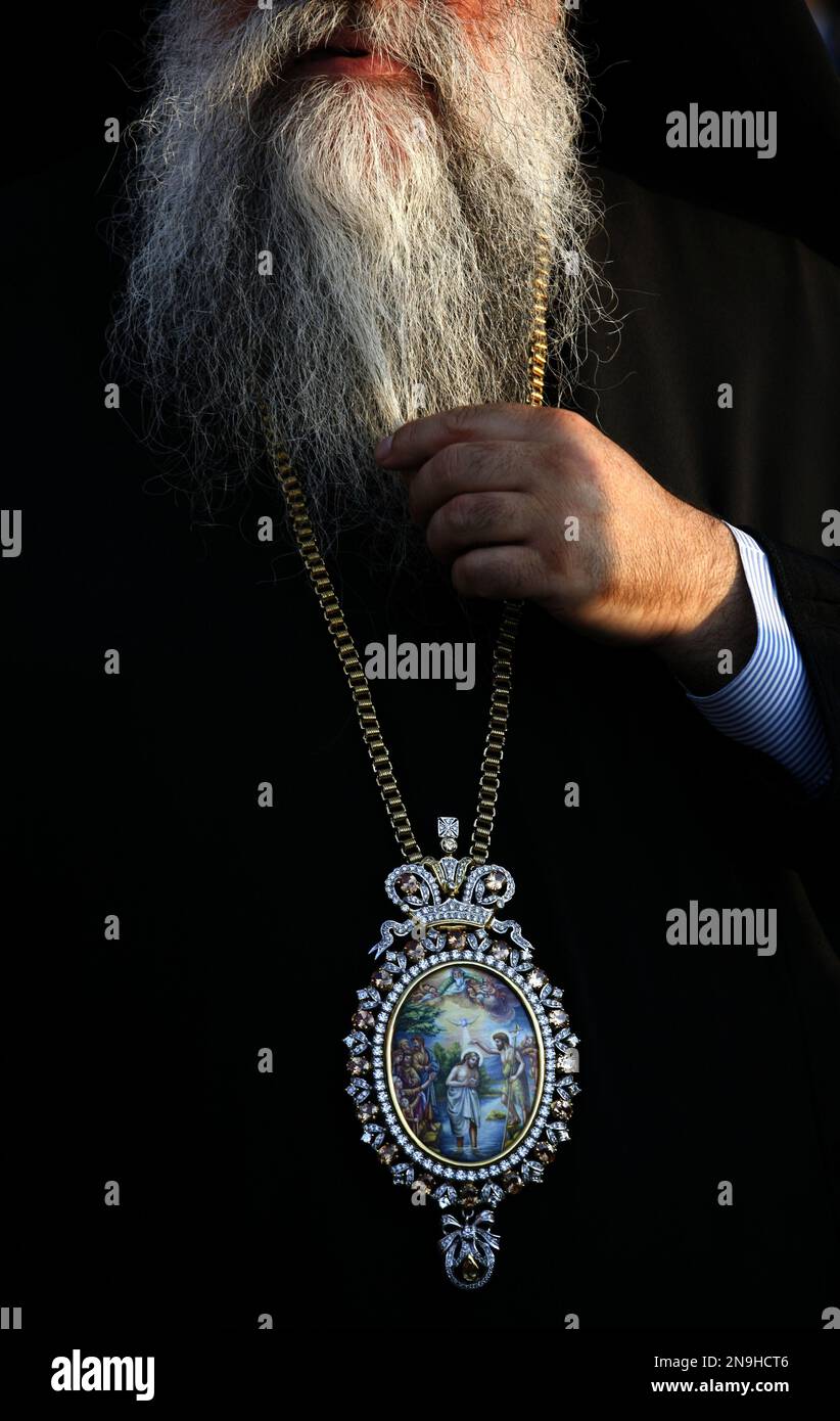In this Tuesday, June 26, 2012 photo a Russian priest strokes his beard ...