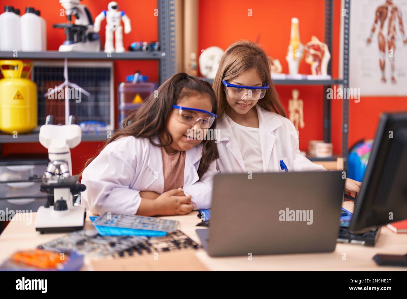Two kids students using laptop at laboratory classroom Stock Photo - Alamy