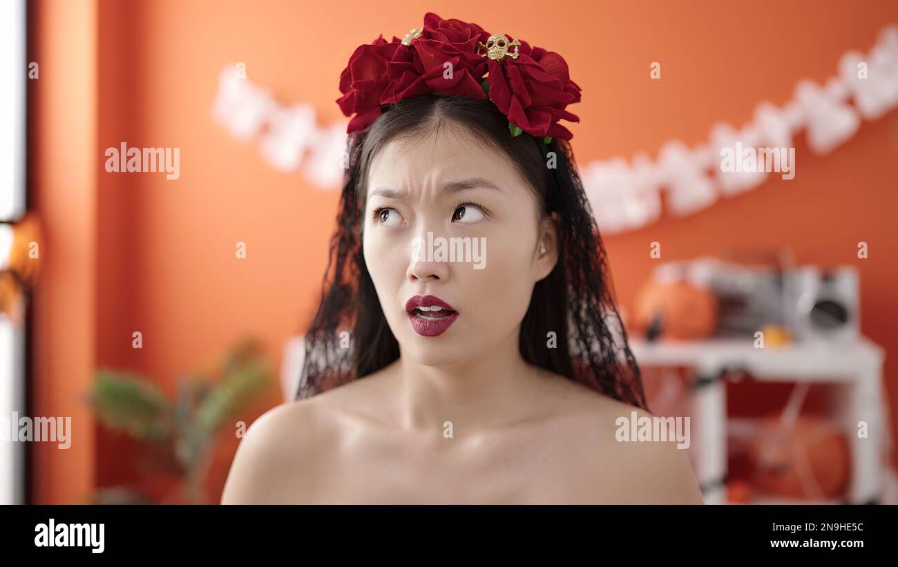 Young chinese woman wearing katrina costume with fear expression at ...