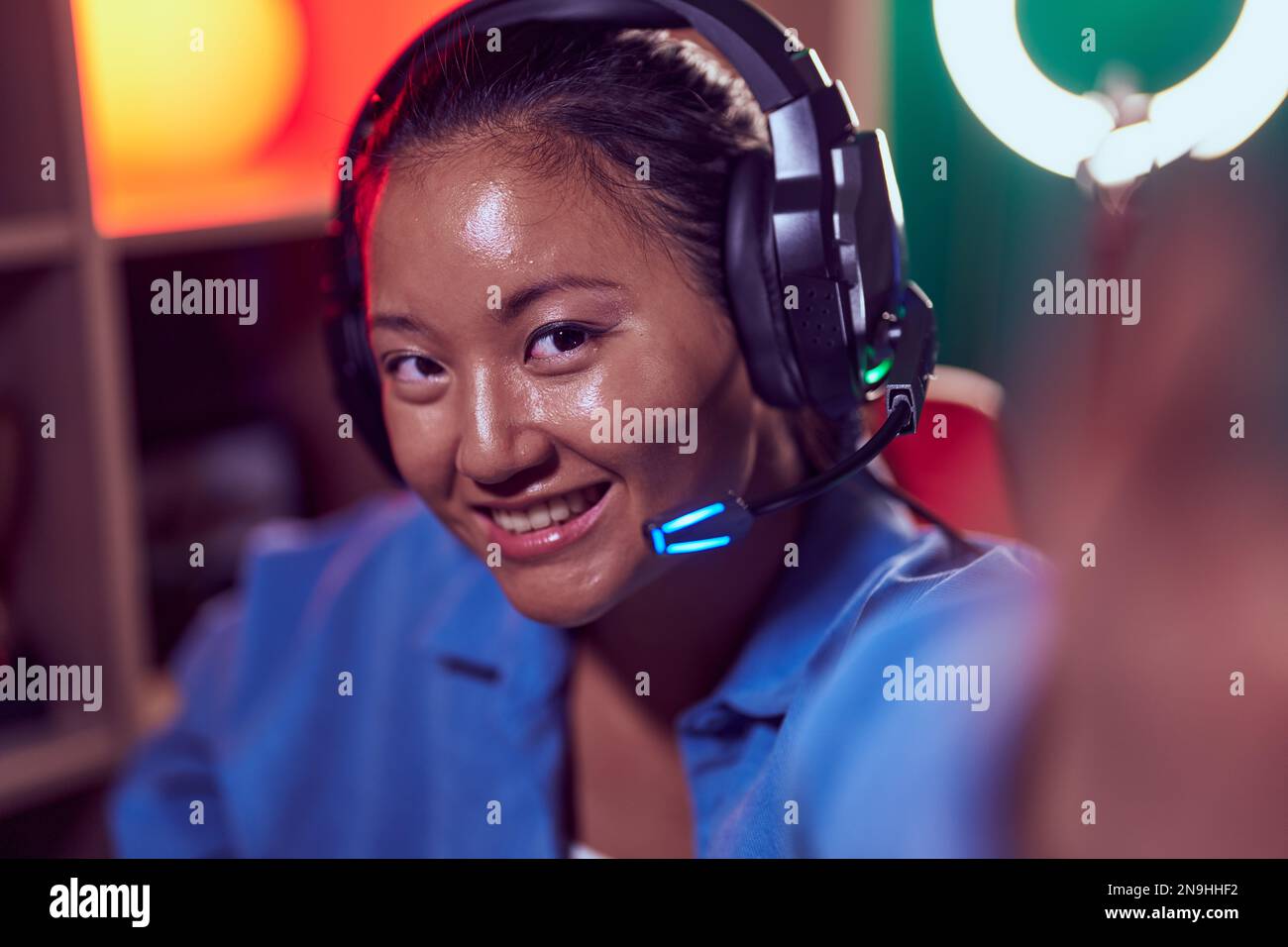 Young chinese woman streamer smiling confident make selfie by camera at ...