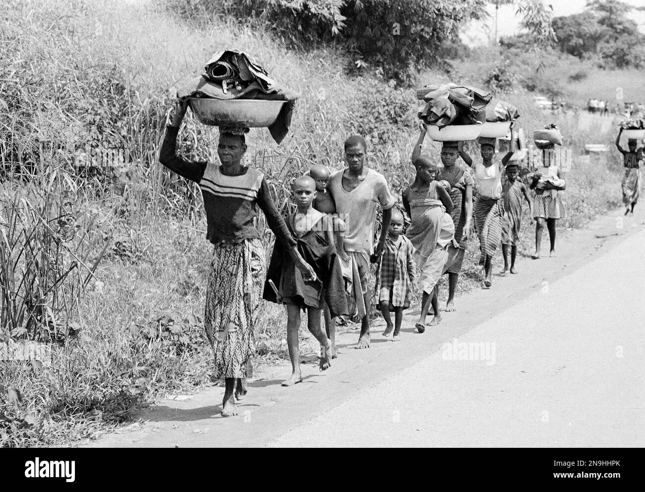 Biafran refugees carry children and belongings as they flee from ...