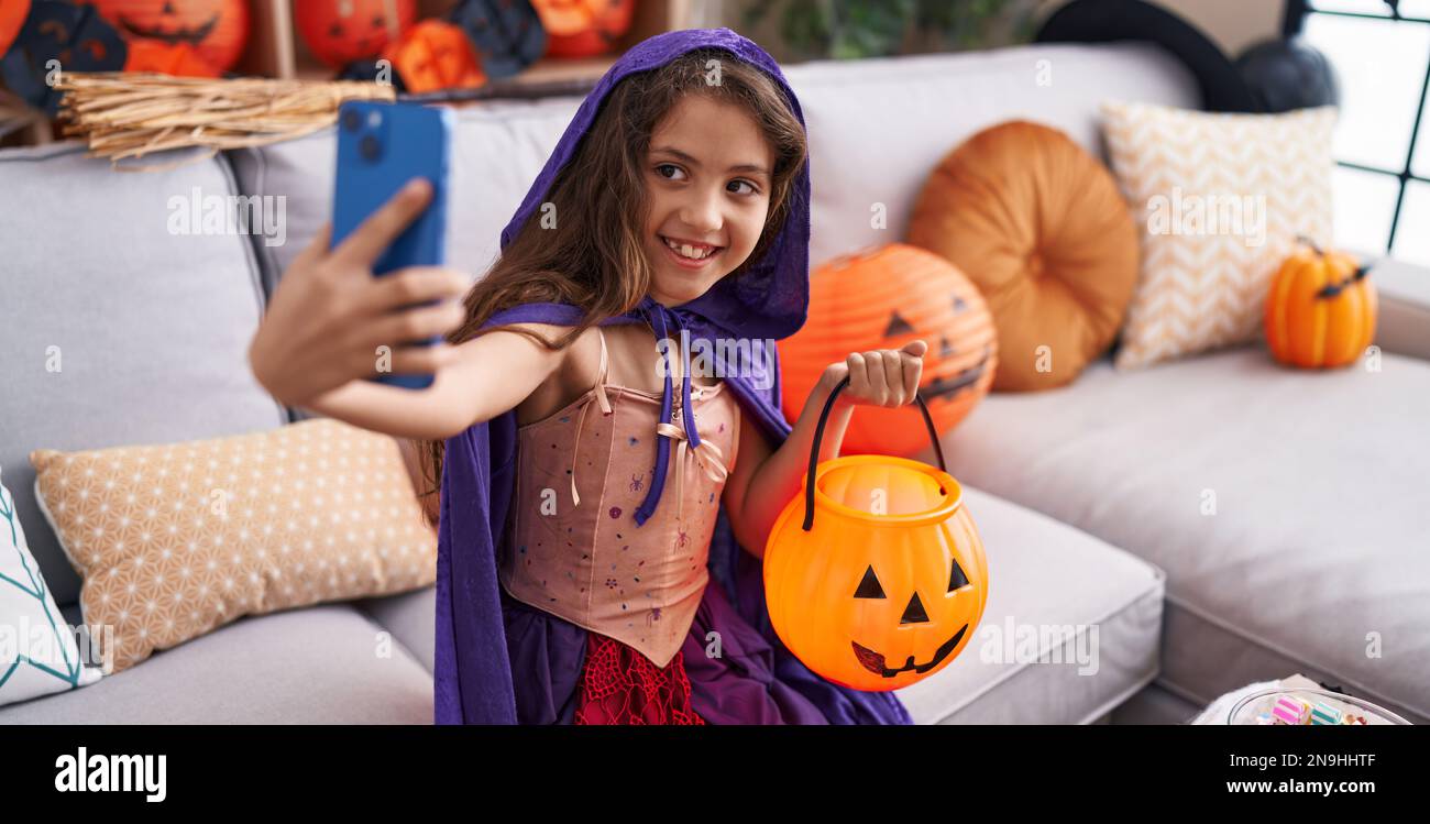 Adorable hispanic girl wearing halloween costume make selfie by ...