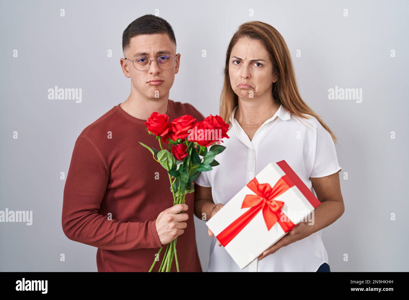 Mother and son holding mothers day gift depressed and worry for ...