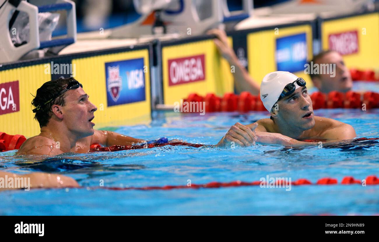 Ryan Lochte, left, and Michael Phelps look at the time after finishing ...