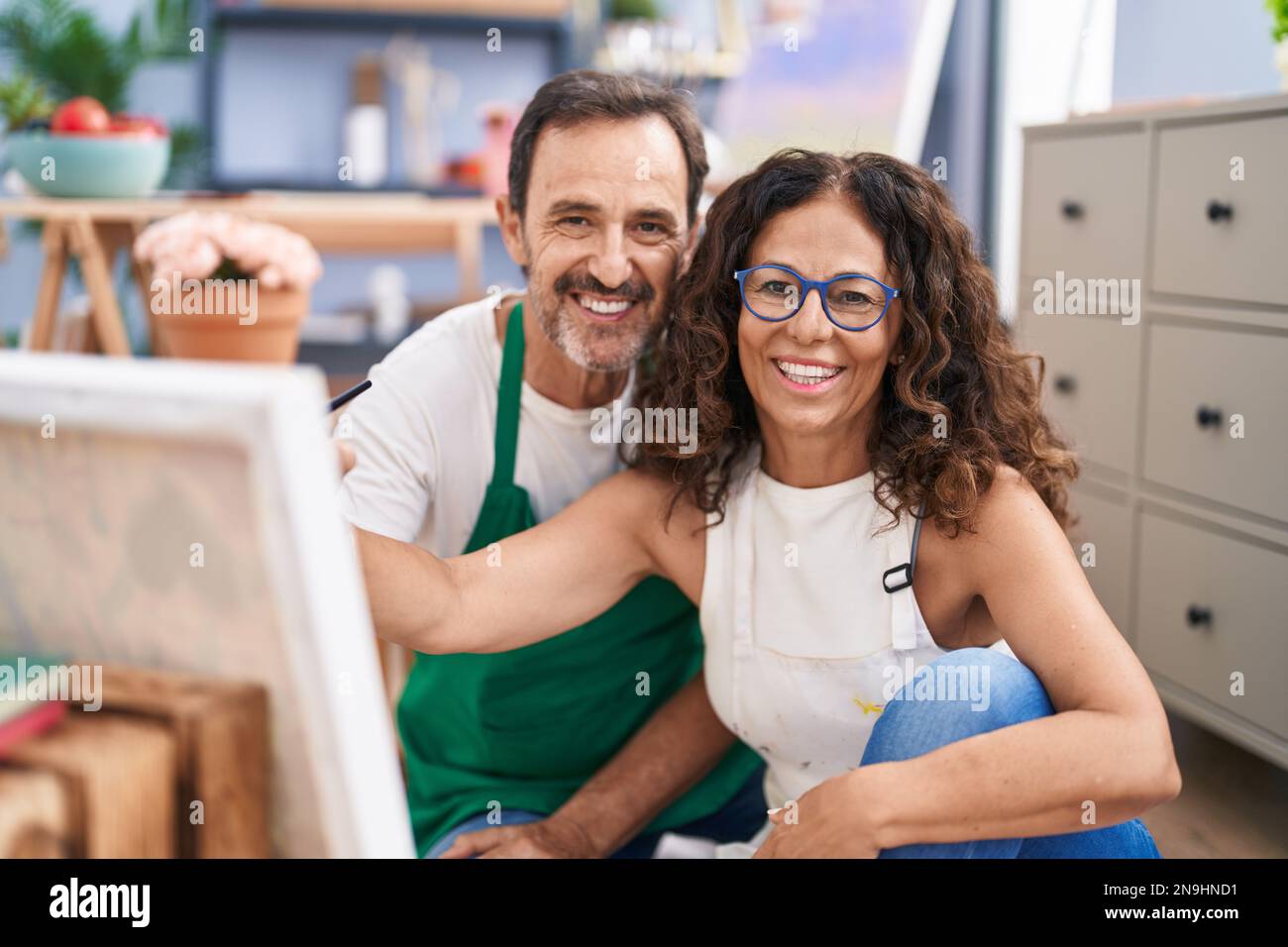 Man and woman artists smiling confident drawing at art studio Stock ...