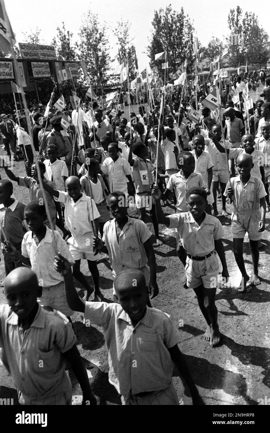 Waving the new red, yellow and green flag of Rwanda, young African ...