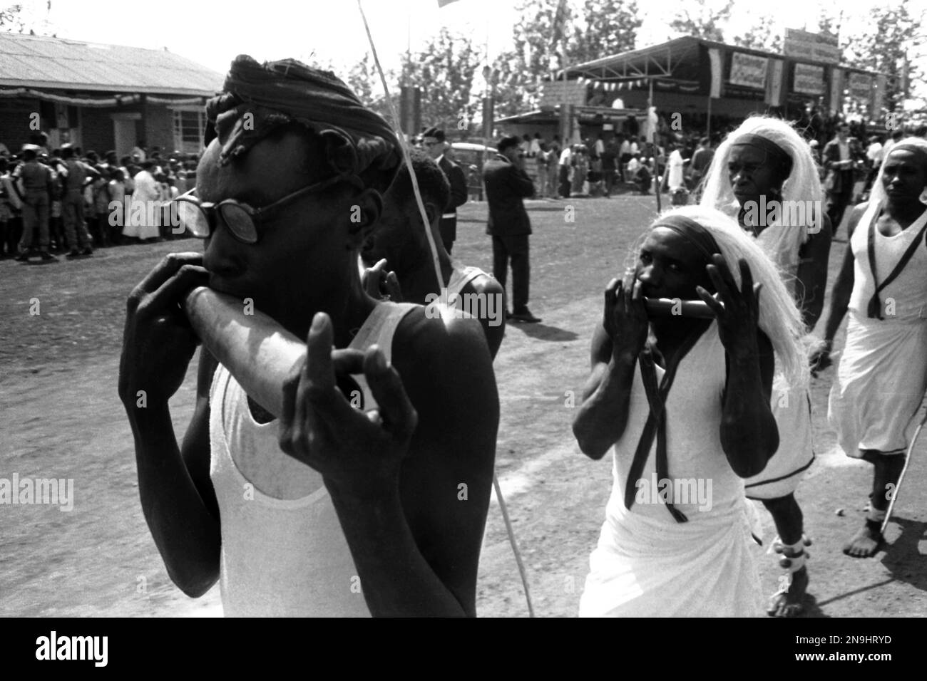 Playing wind instruments, local musicians parade through the streets of ...