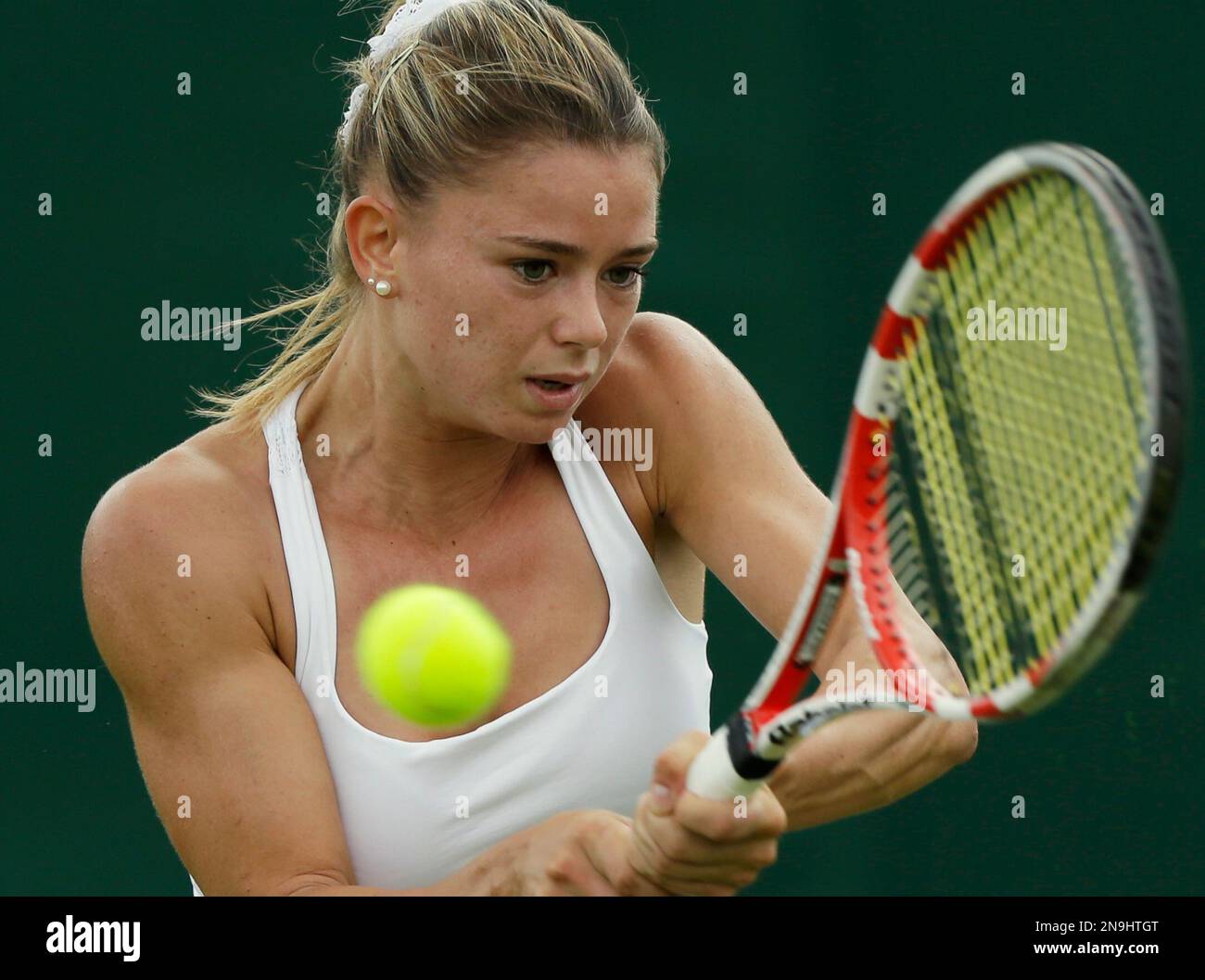 Camila Giorgi of Italy returns a shot to Flavia Pennetta of Italy ...