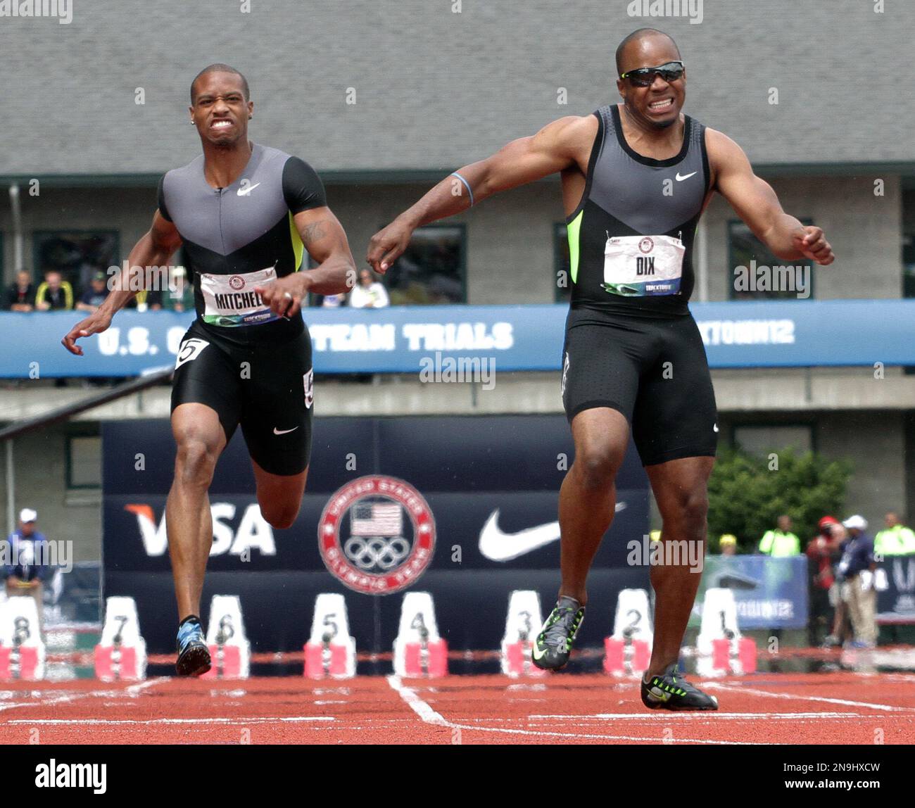 Walter Nix grimaces as he crosses the finish line during a men's 100m ...