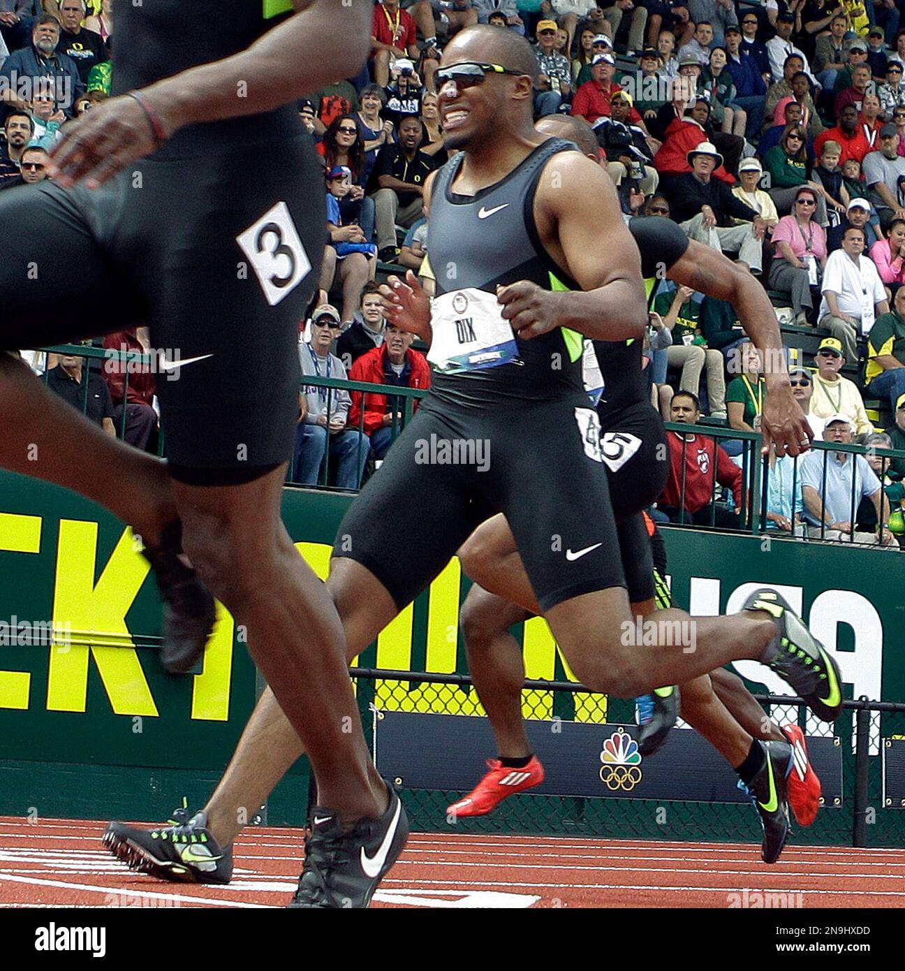 Walter Nix grimaces as he crosses the finish line during a men's 100m ...