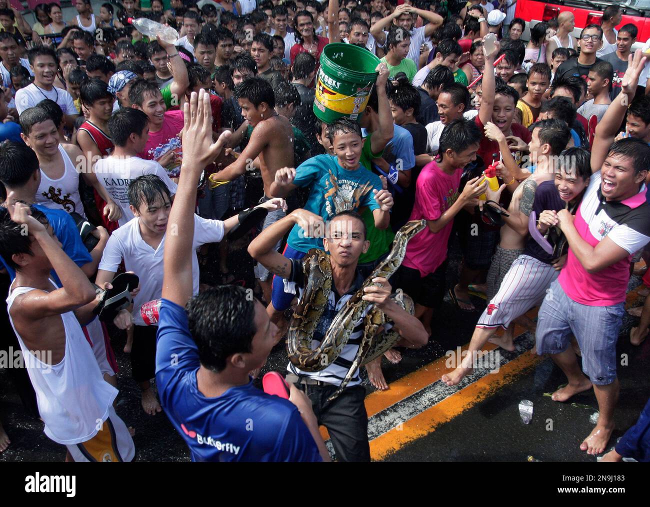 A resident shows his pet snake during celebrations of the feast of ...