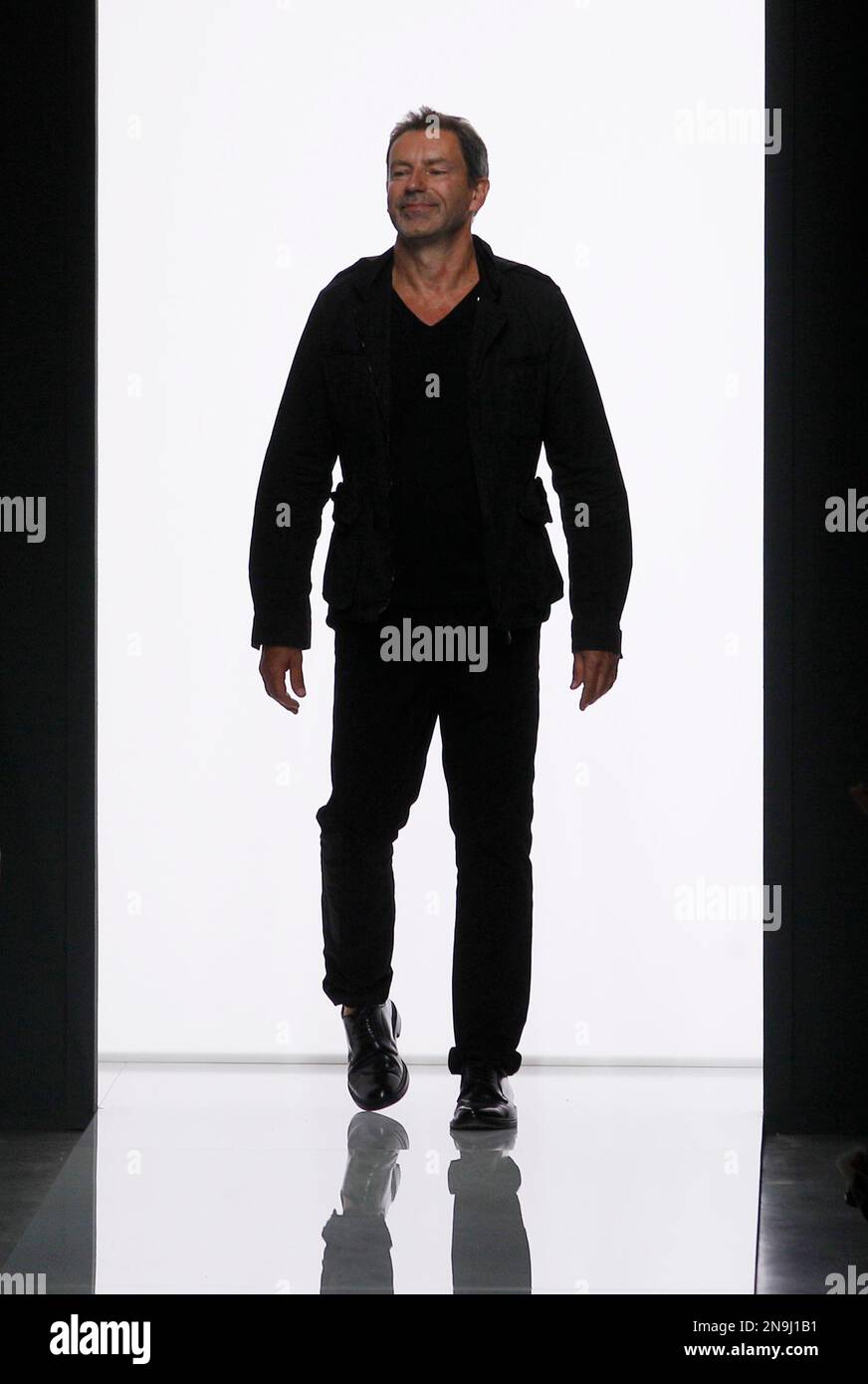 Bottega Veneta creative director Tomas Maier acknowledges the applause ...