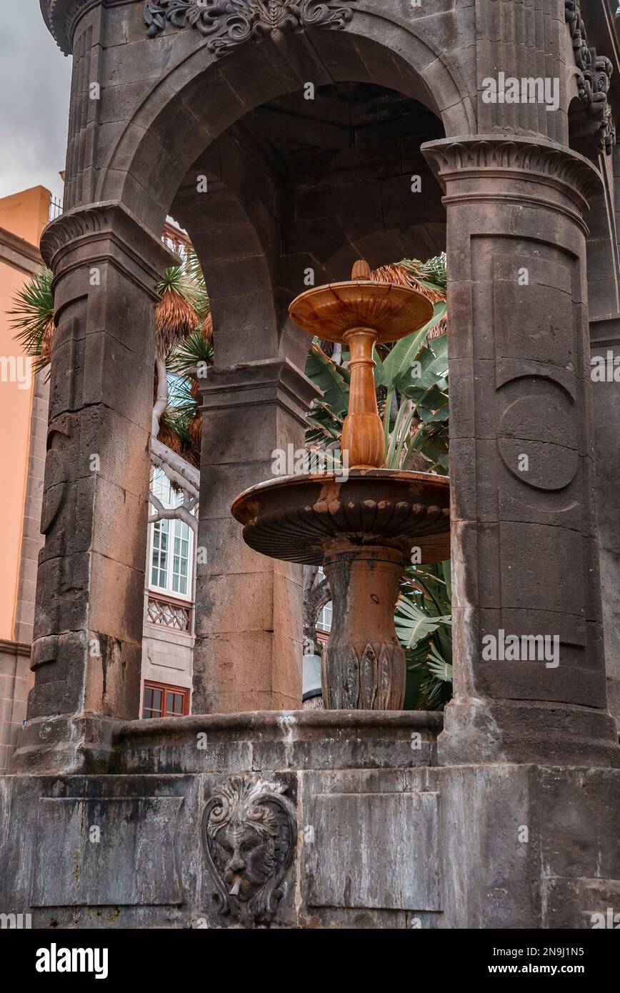 Fountain with medieval structure seen through arch at Plaza del ...