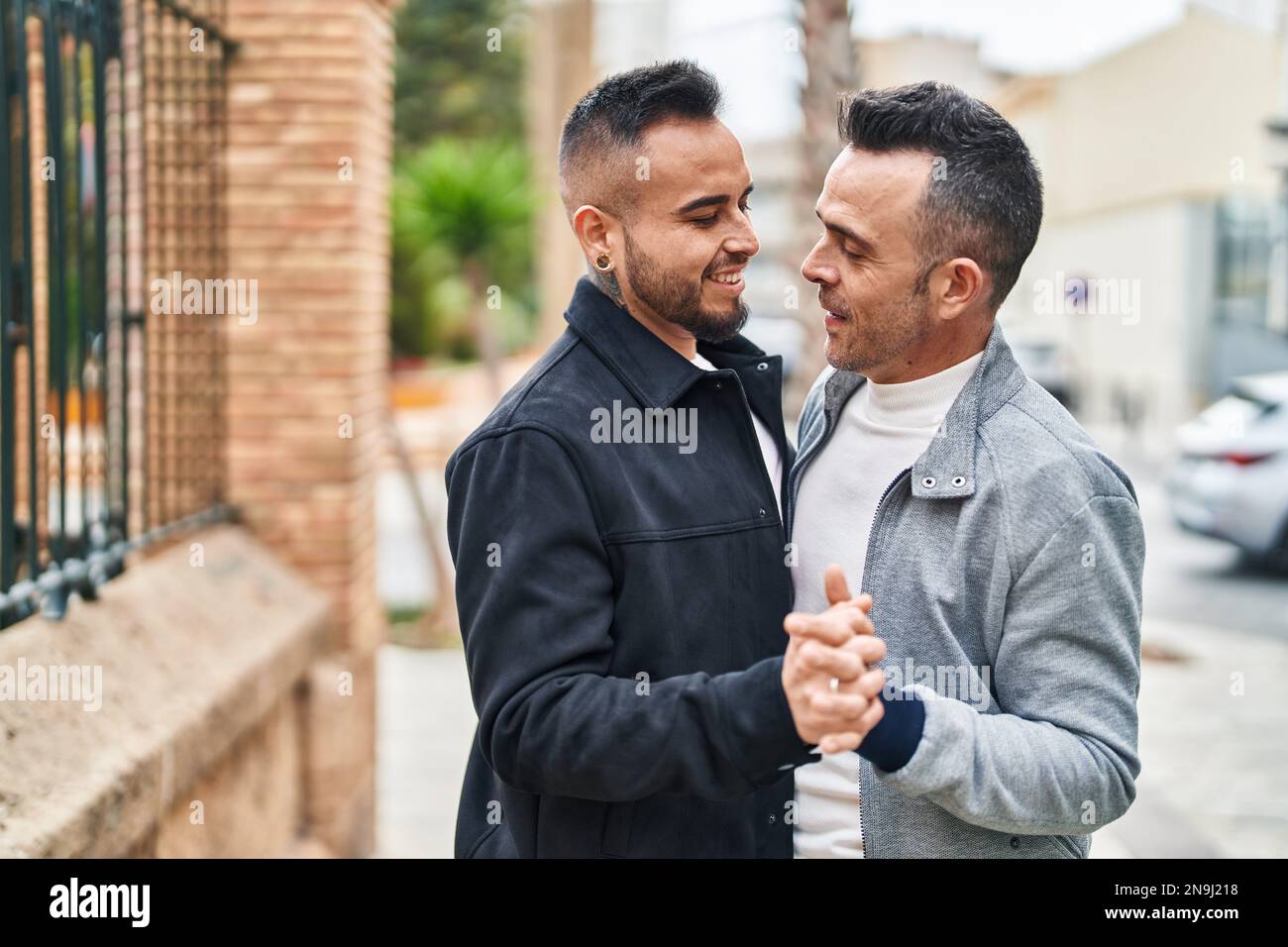 Two men couple smiling confident dancing at street Stock Photo - Alamy