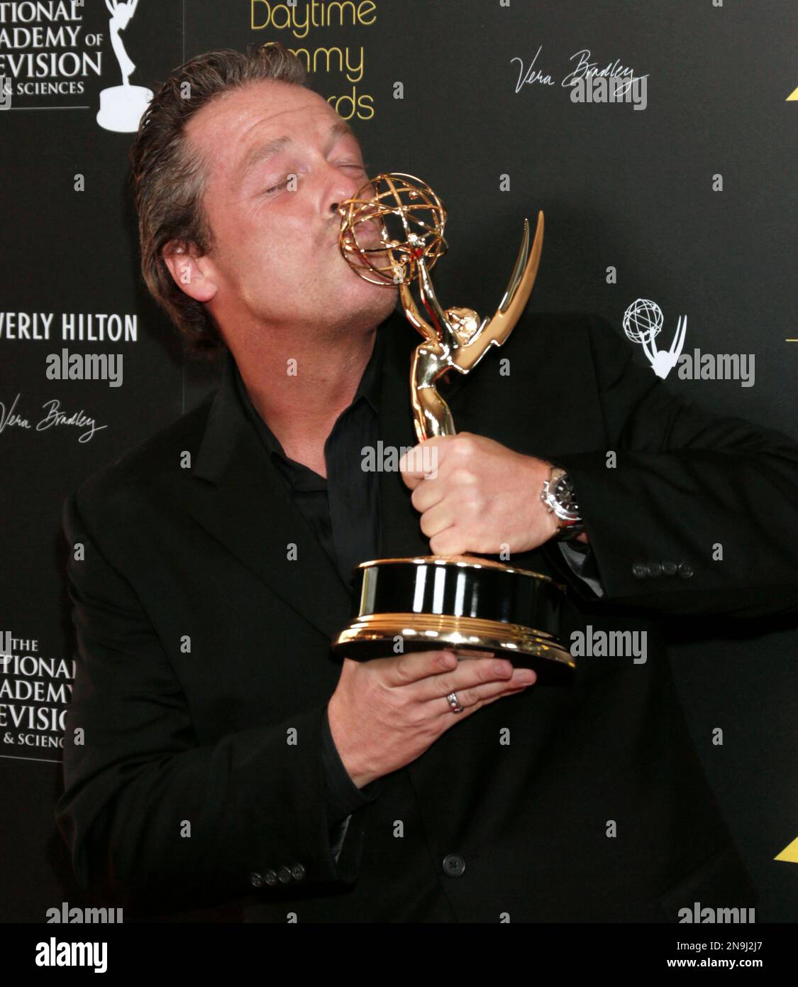 Todd Newton poses backstage with the game show host award for "Family ...