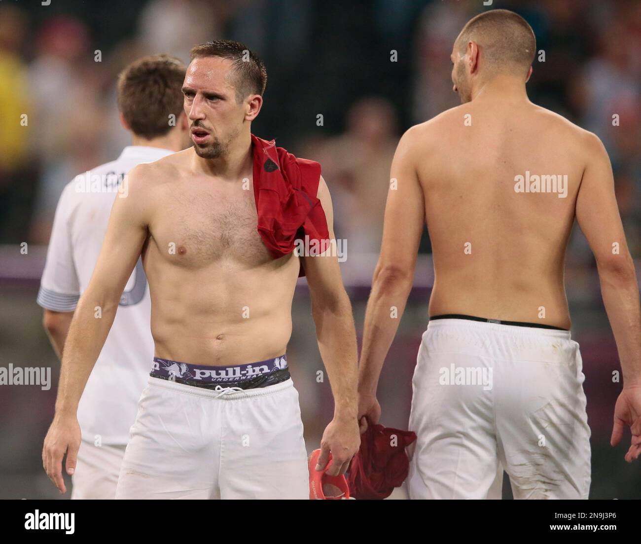 France's Franck Ribery, left, walks past teammate Karim Benzema during ...