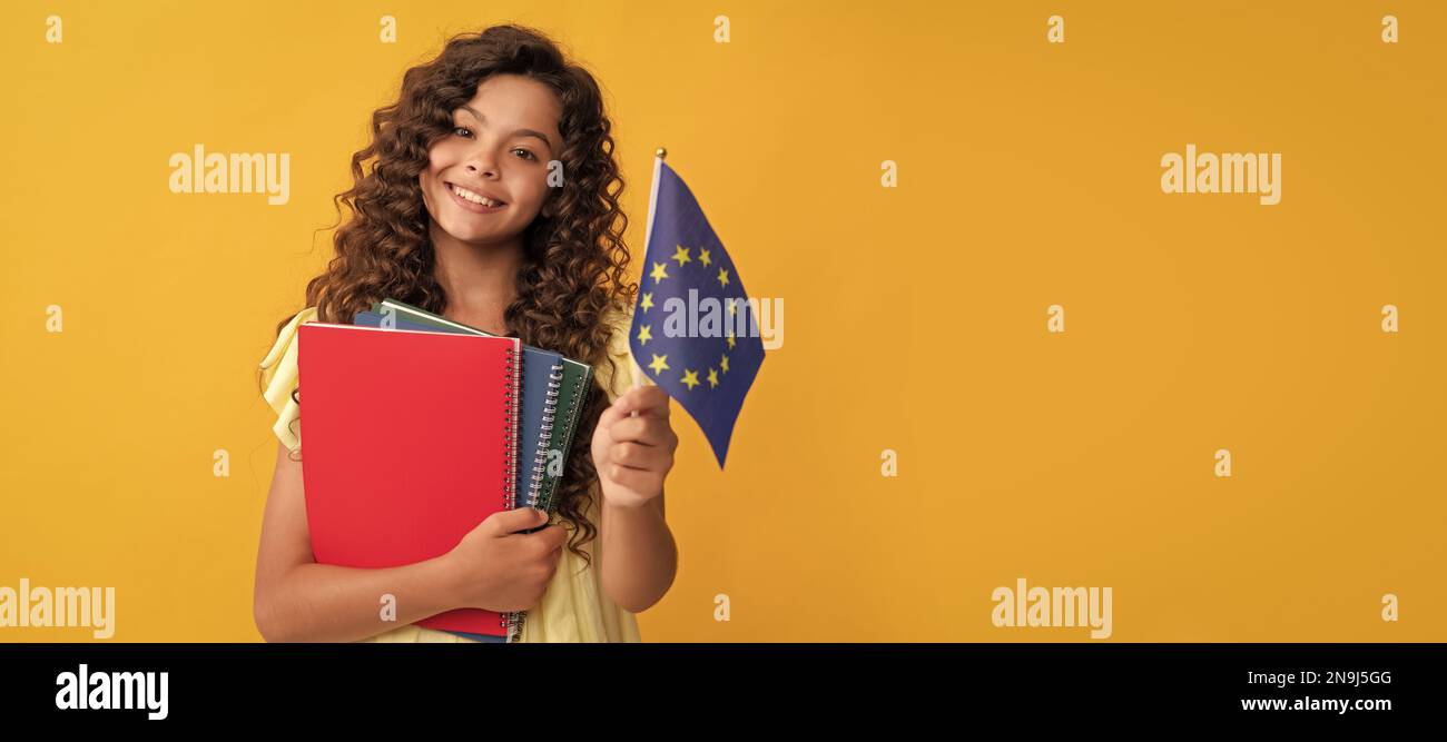 happy teen girl study with school workbooks hold european union flag ...