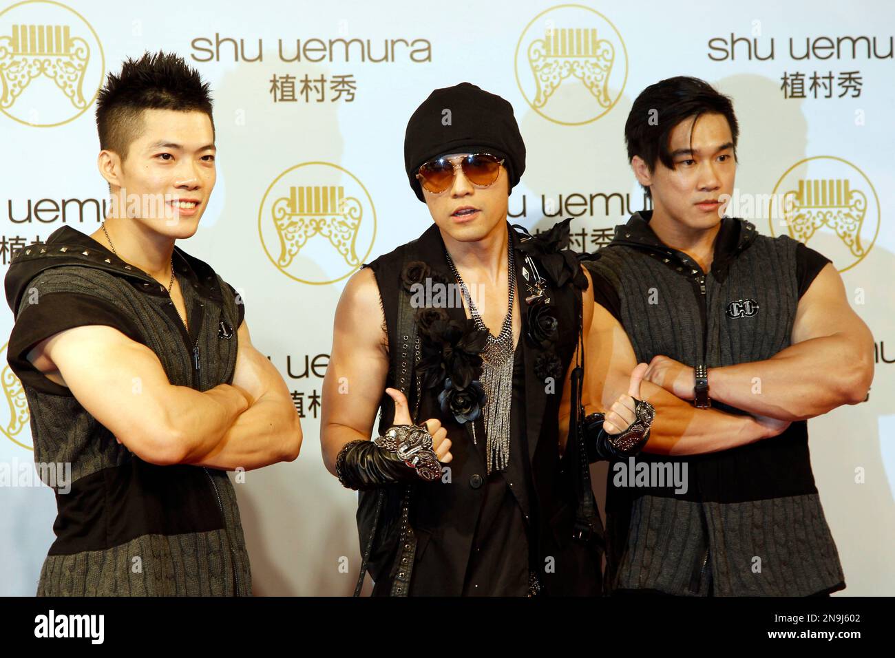 Taiwan singer Jay Chou, center, arrives with his body building trainers ...
