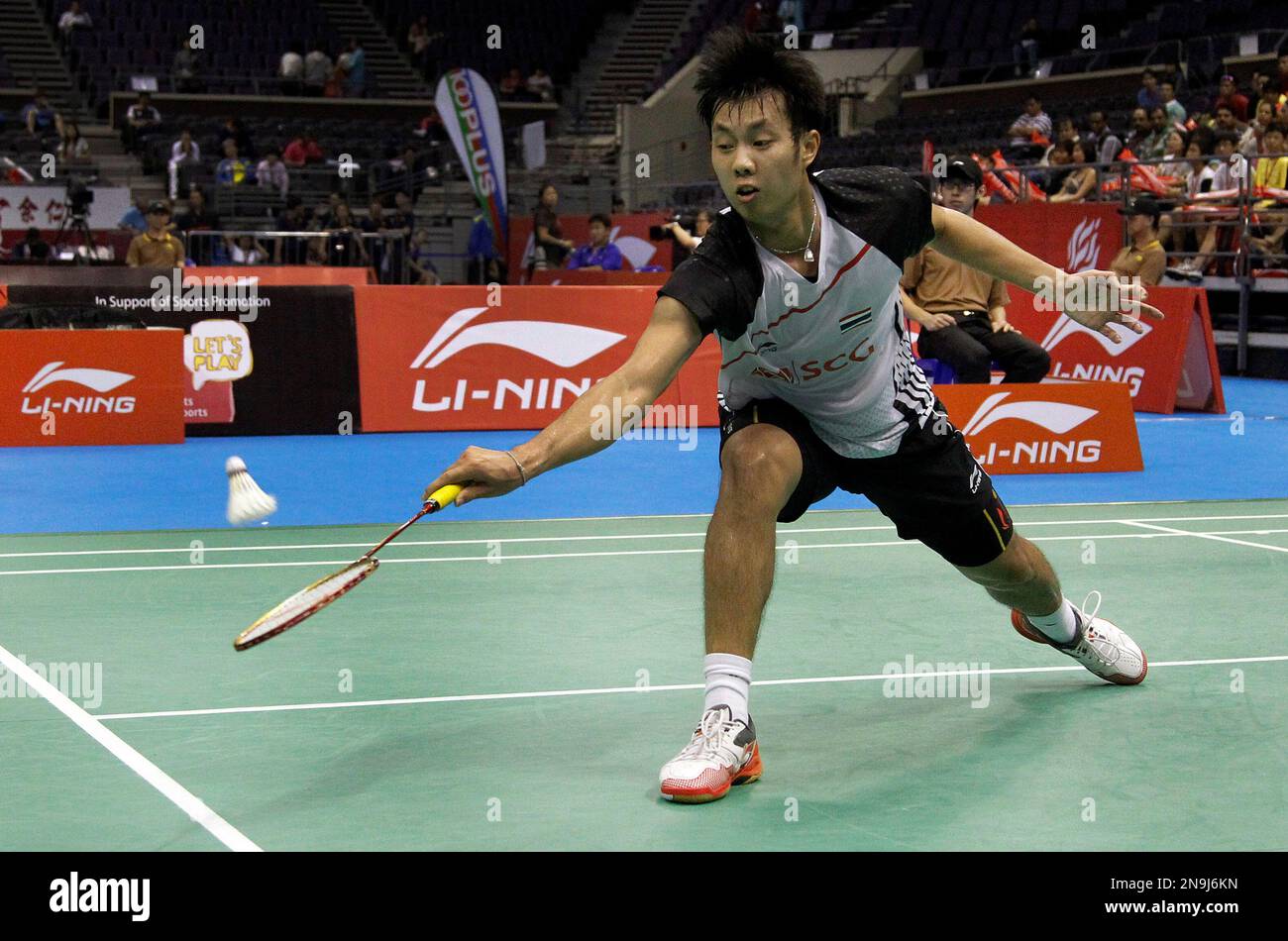 Thailand's Boonsak Ponsana returns a shot to Vietnam's Nguyen Tien Minh ...