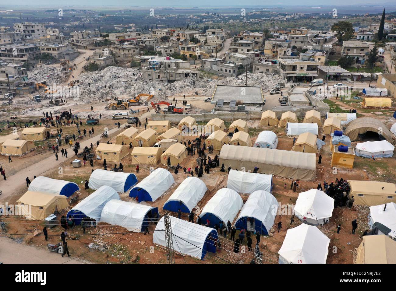 FILE - Volunteers set up tents for Families who lost their homes in a ...