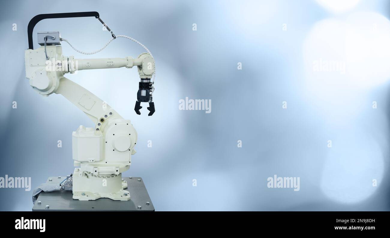 Modern handling robot with robotic arm Stock Photo - Alamy