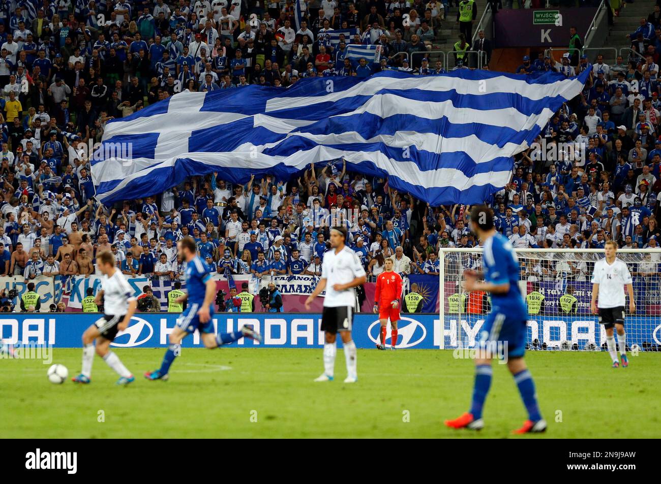 Greek fans display a giant national flag during the Euro 2012 soccer ...
