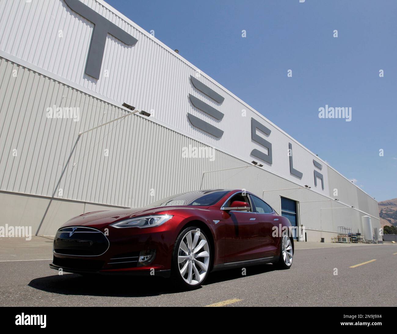 A Tesla Model S drives outside the Tesla factory in Fremont, Calif ...