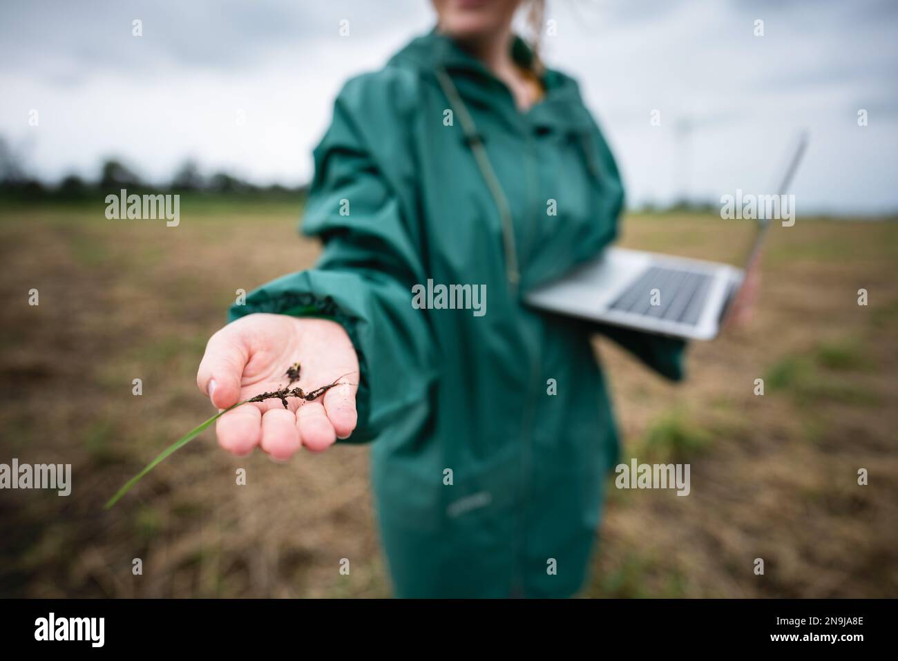 Farmer with laptop on the field. Smart farming and agriculture ...