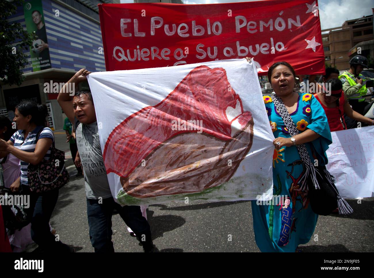 Pemon Indigenous people, carrying a banner with a drawing depicting the ...