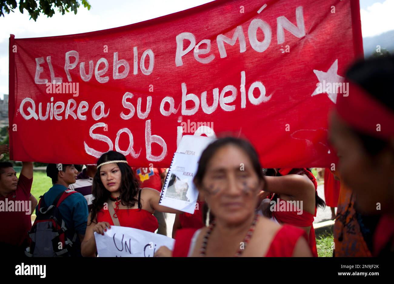 Carrying a banner that reads in Spanish "The Pemon people love their ...