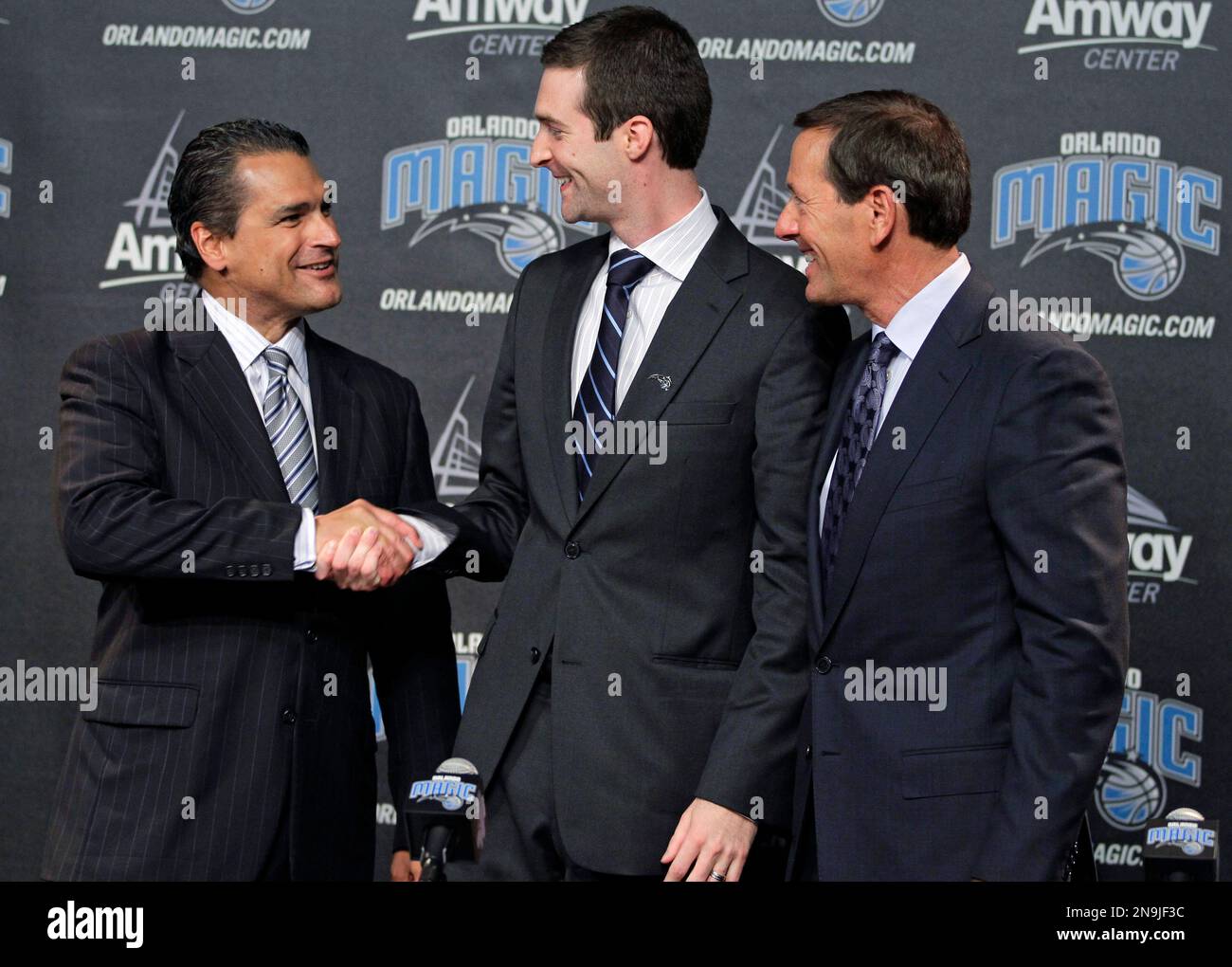 Orlando Magic CEO Alex Martins, left, shakes hands with Rob Hennigan ...