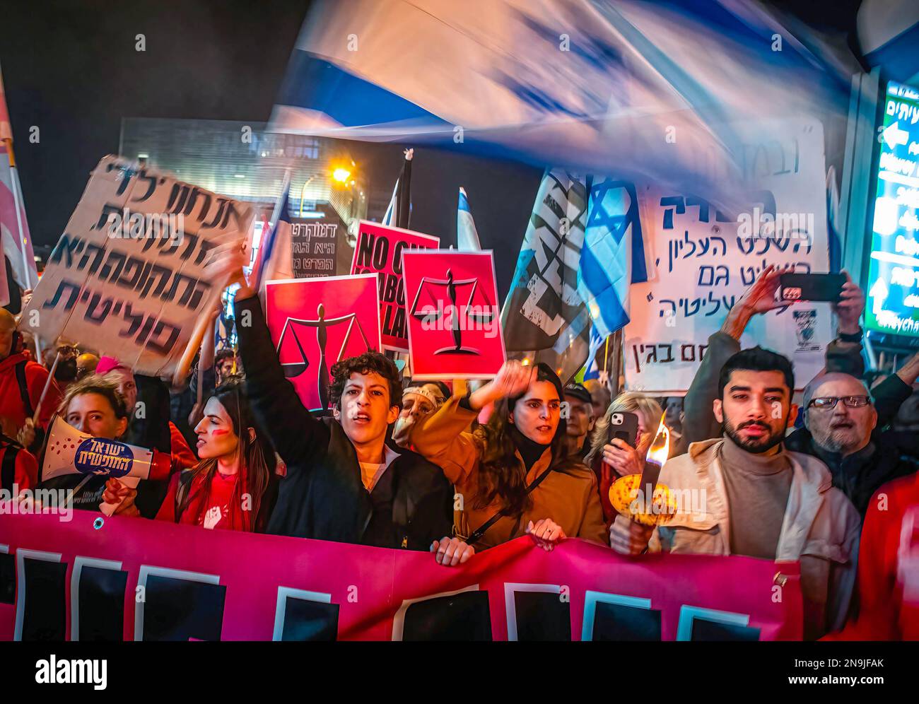 Tel Aviv, Israel. 11th Feb, 2023. Protestors hold Israeli flags ...